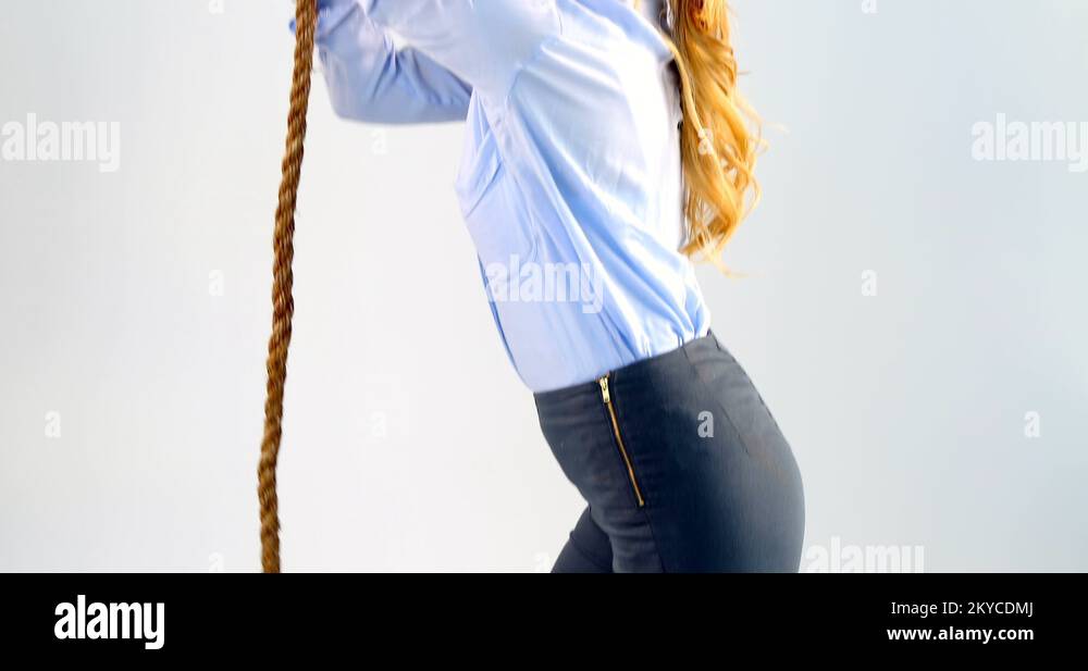 Woman pulling a rope against white background 4k Stock Video Footage ...