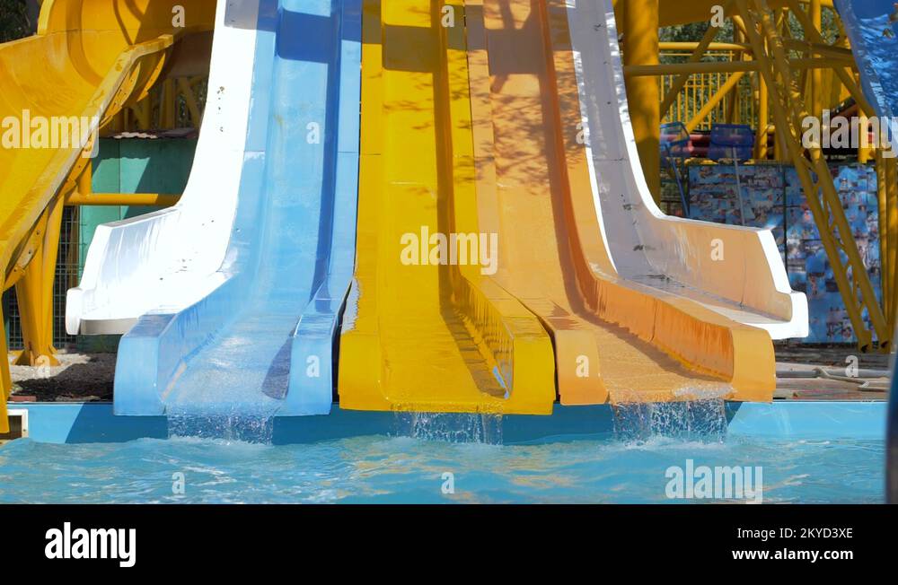Summer Fun At Water Park Brave Girls Sliding Down On Waterslides And