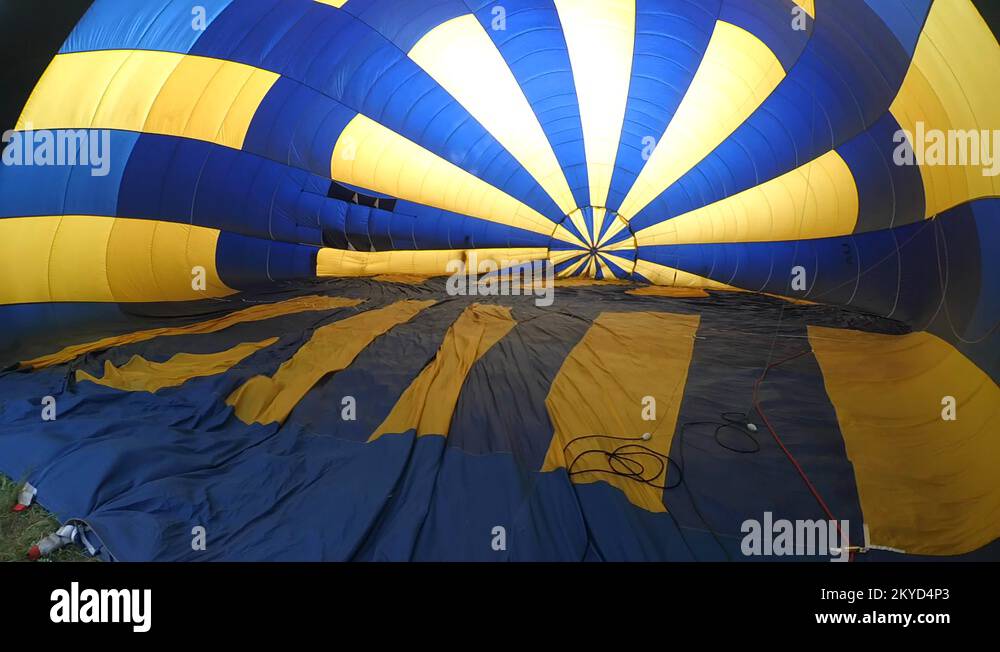 Inflation of a large balloon aerostat that lies on the ground Stock ...