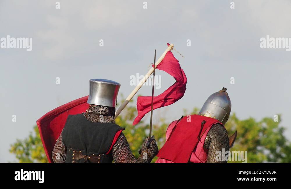 Two men in medieval armor on horseback fighting in a jousting ...