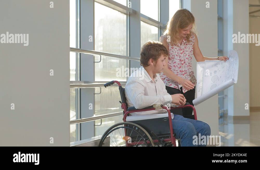 disabled businessman on a wheelchair in a window with a picture on a ...