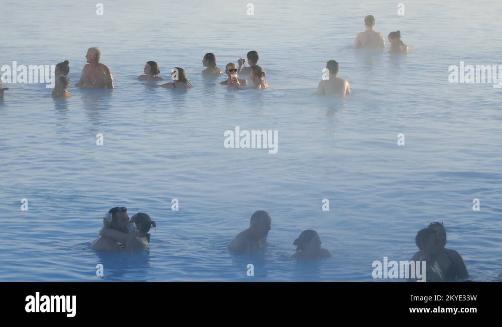 Crowd of people enjoying spa In geothermal mineral hot spring Blue ...