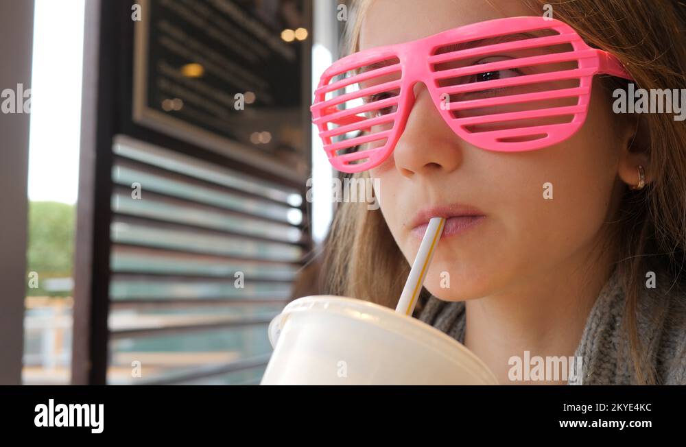 11 Kid girl face portrait in party glasses drinking cola from straw in ...