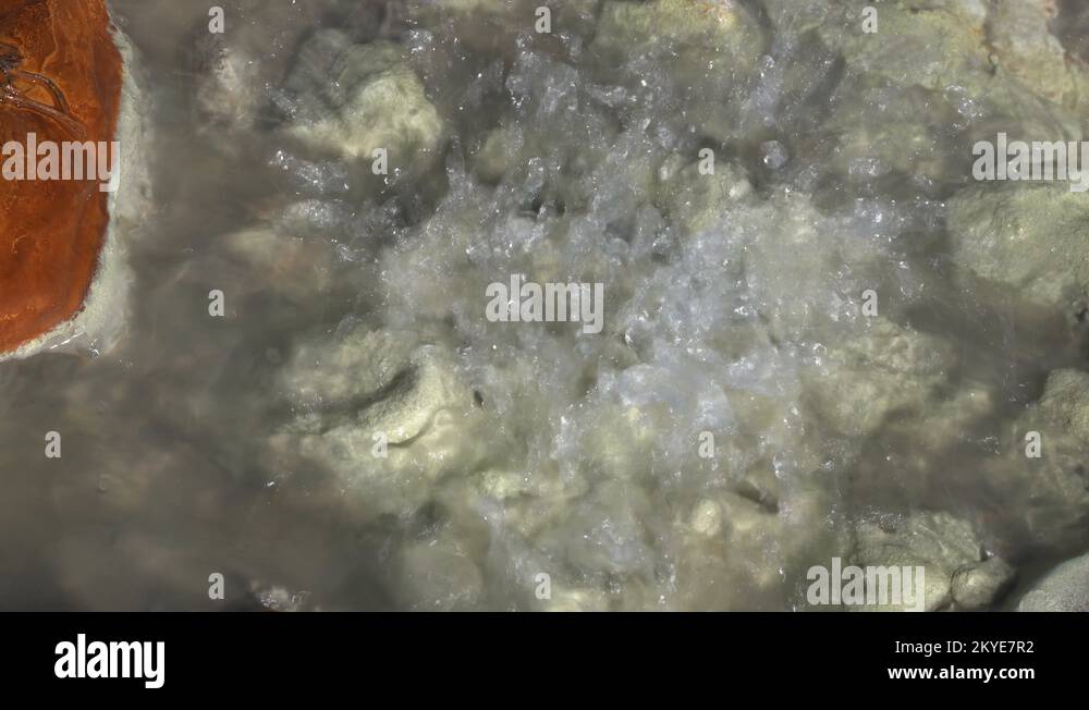 Natural aggressive volcanic hot springs splashing of bubbling mineral ...