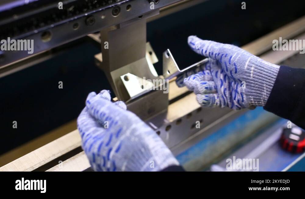 Man working with sheet metal and special machine tools for bending ...