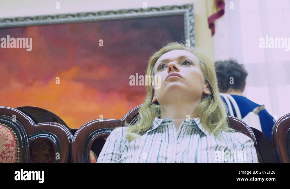 beautiful woman looks at the pictures in the picture gallery. art ...