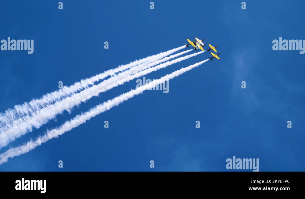 Five airplanes flying on background of blue sky, leaving a condensation ...