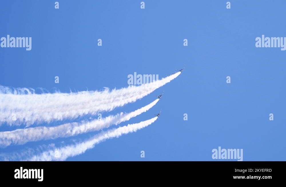 Five airplanes flying on background of blue sky, leaving a condensation ...