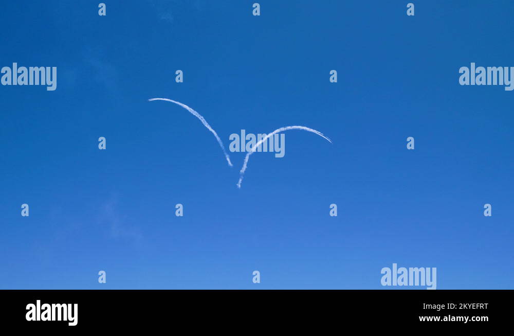 Five airplanes flying in sky, leaving condensation trail in shape of a ...