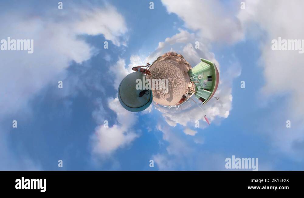 woman walks on the beach with a surfboard-Tiny World Effect Stock Video ...