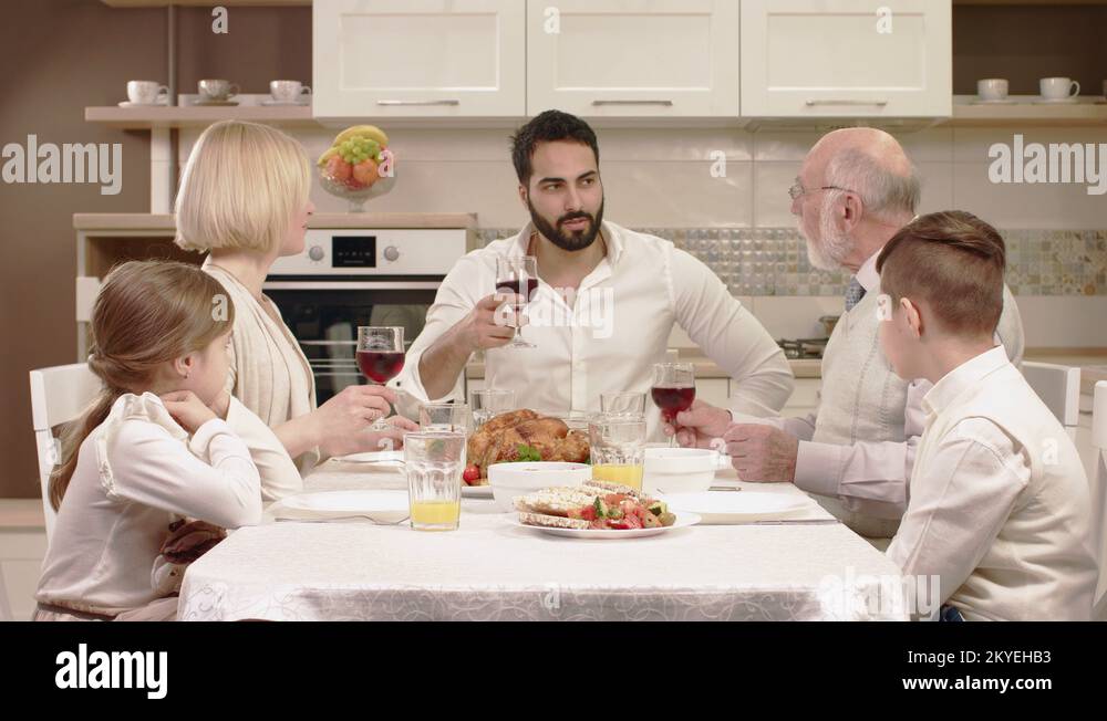 Family Sitting Around a Table, Eating, Communicating and Having Fun ...