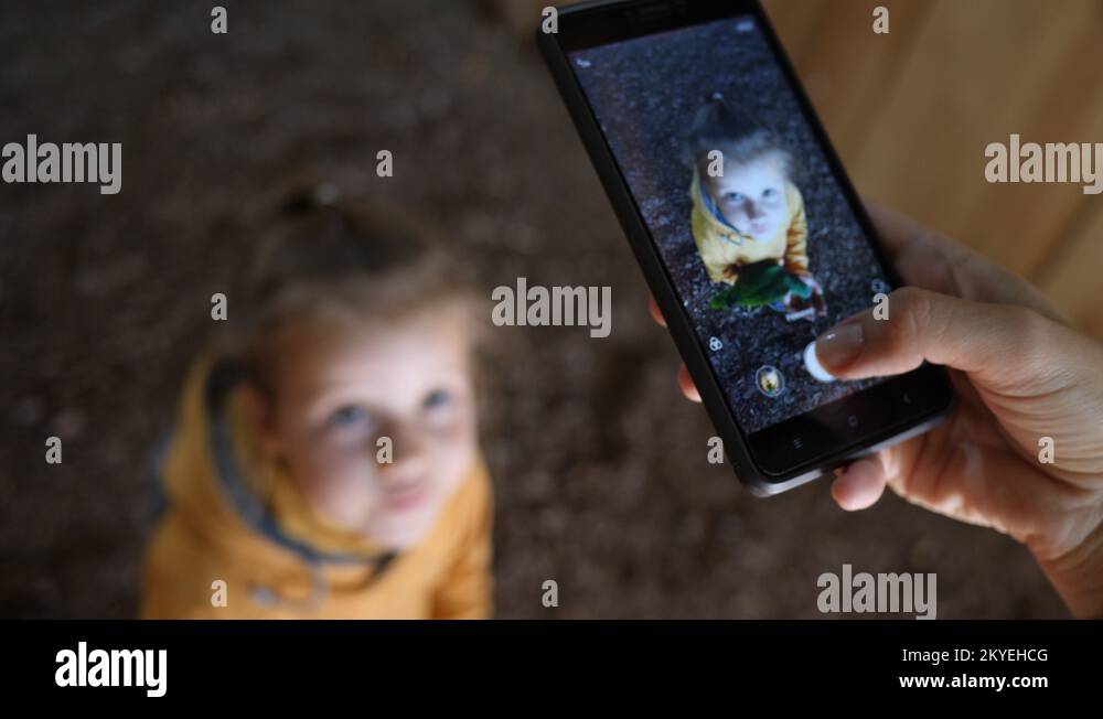 From top mother take smartphone pictures of child girl daughter hold ...