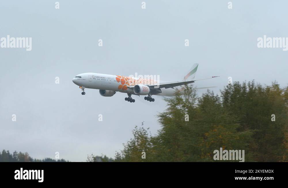 huge emirates boeing 777 yellow expo 2020 logo landing runway wet humid ...
