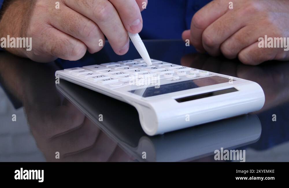 Man Hands Image on the Desk Calculating Using a Pen and Adding Machine ...