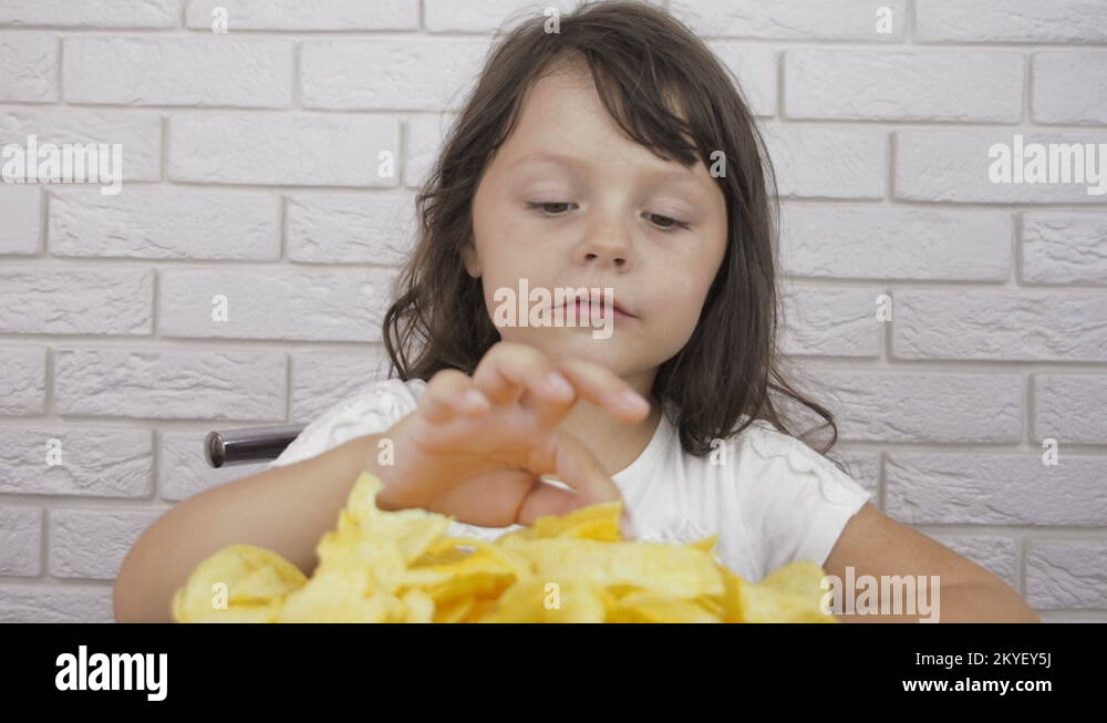 Junk food. Child eating chips Stock Video Footage - Alamy