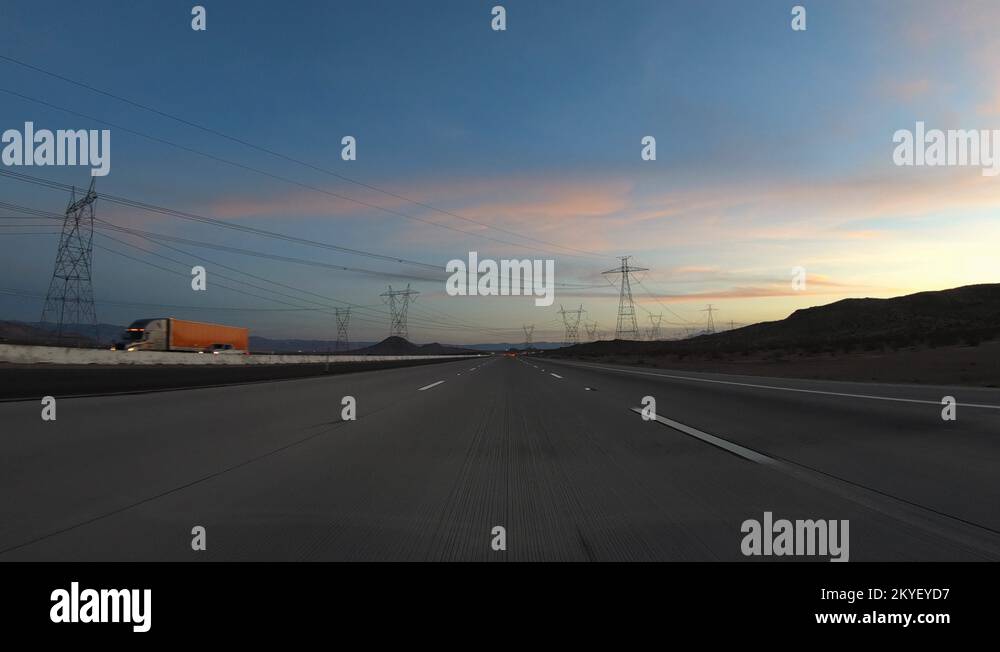 Dusk Driving Under Power Lines on Interstate 15 in California Stock ...