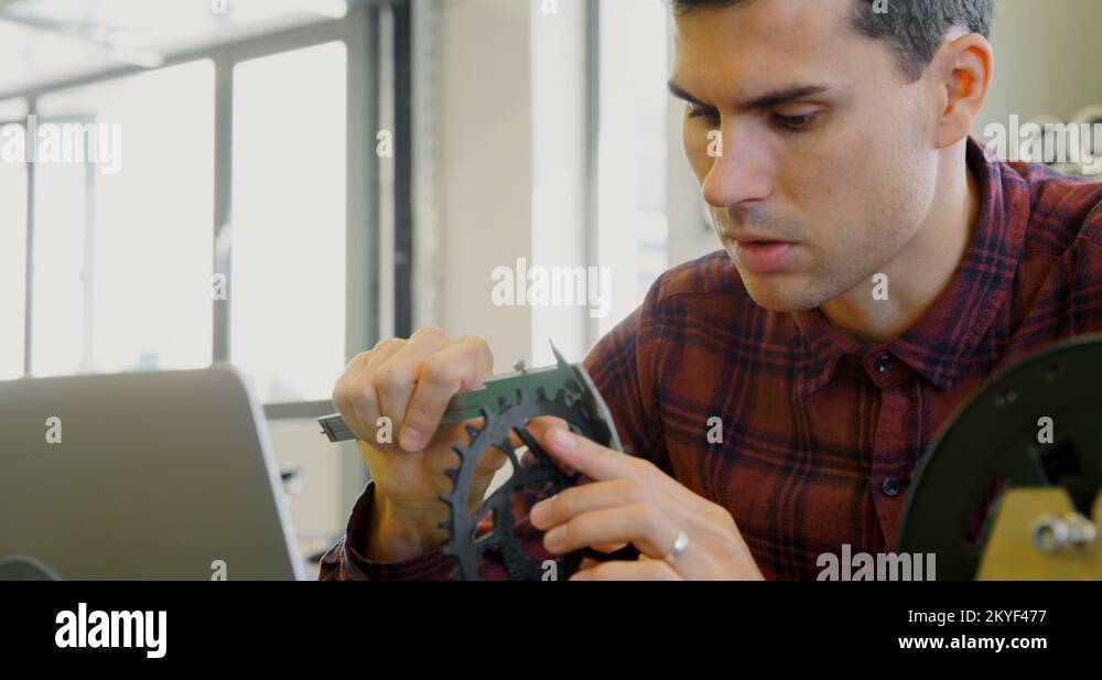 Mechanic checking diameter of chain ring with vernier calipers 4k Stock ...