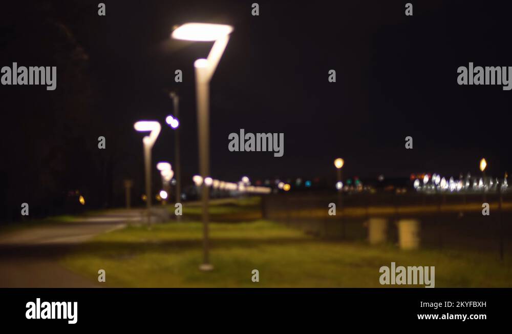 Video background of an empty jogging path with street lights near a ...