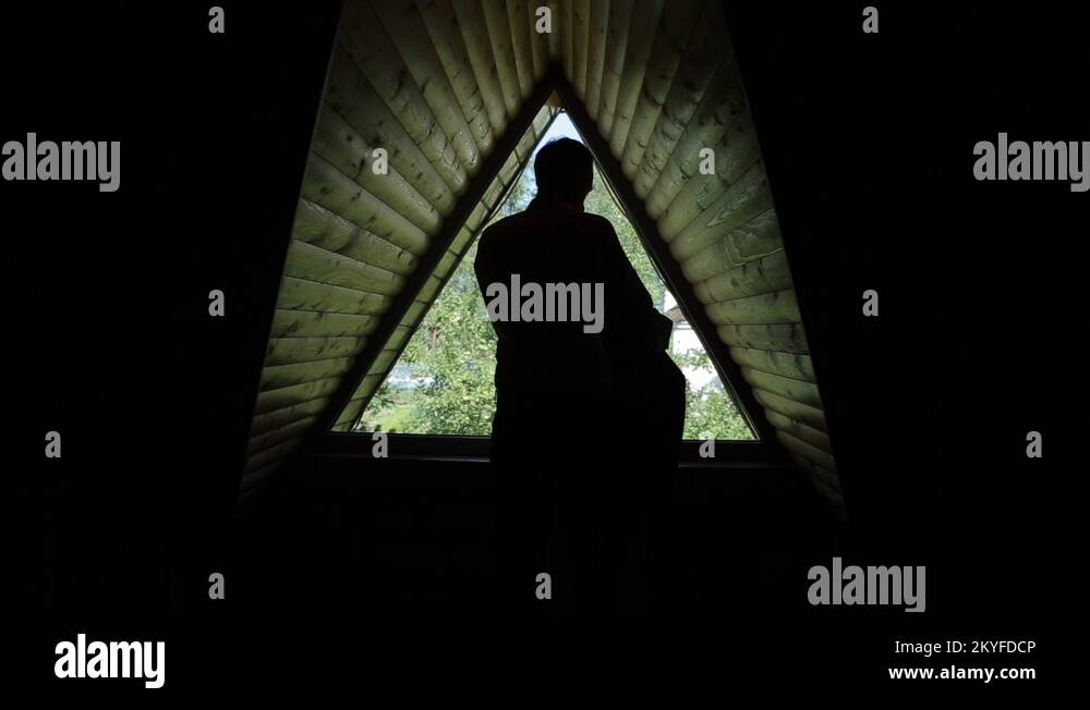 A back view of a man putting on a jacket in front of a triangular ...