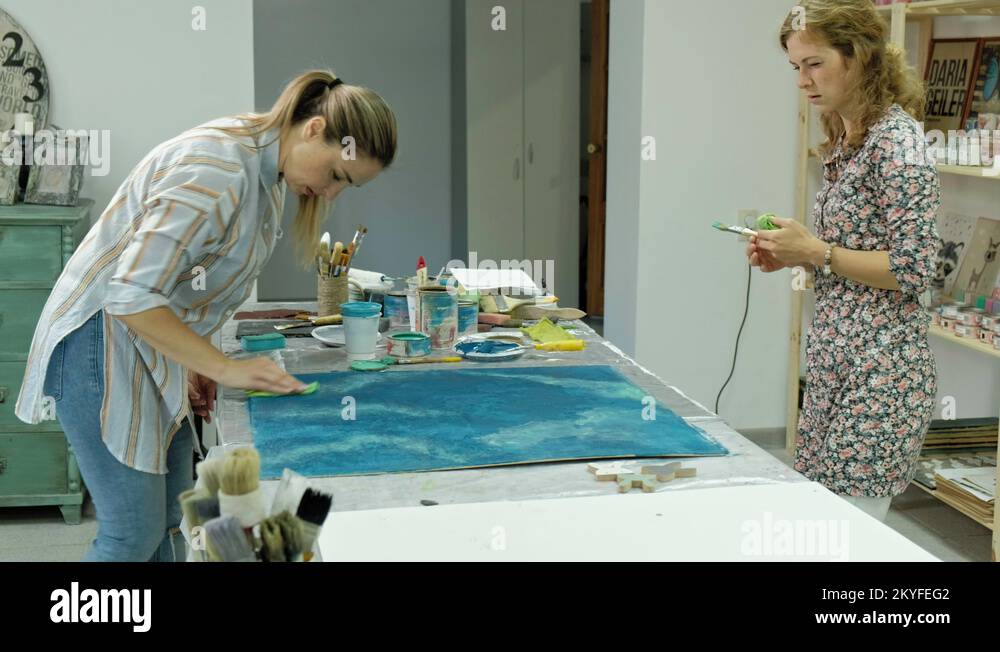 Masters in the art studio process the wood with paint and putty ...