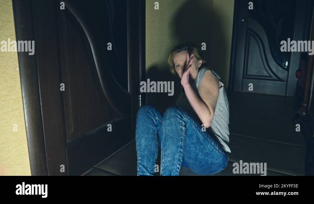 horror, a girl crawls away from her investigator, falling to the floor ...