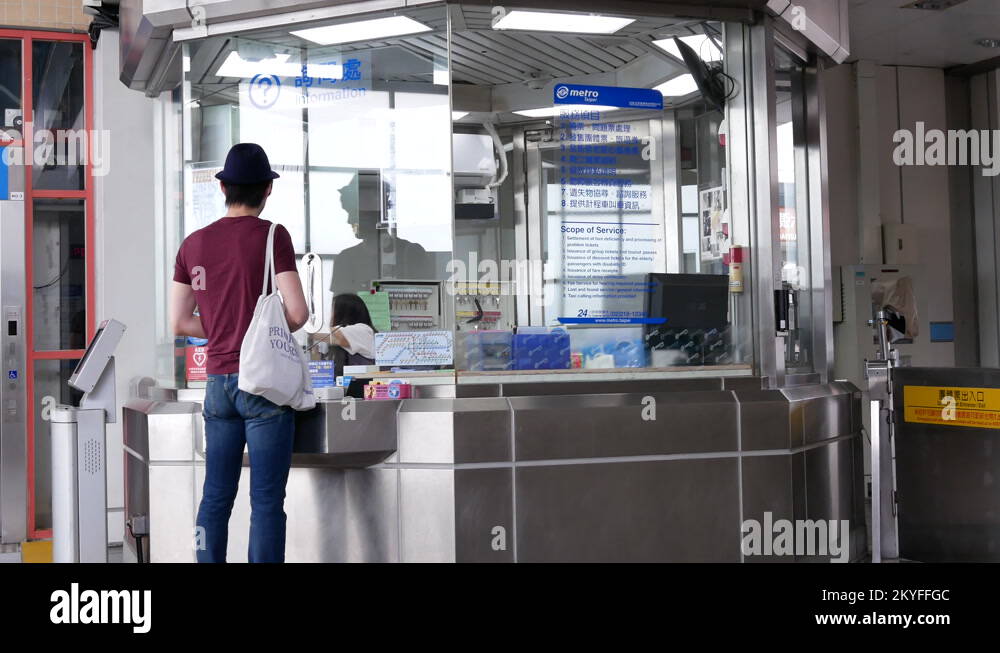 Motion of people asking question at information center inside the MRT ...