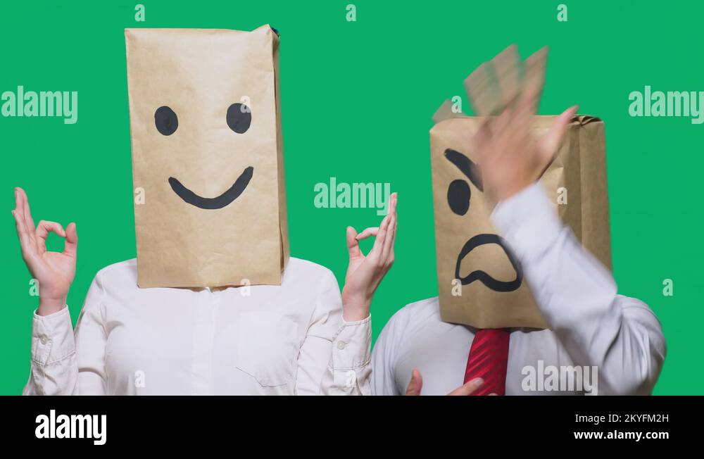 The concept of emotions and gestures. Two people in paper bags on the ...