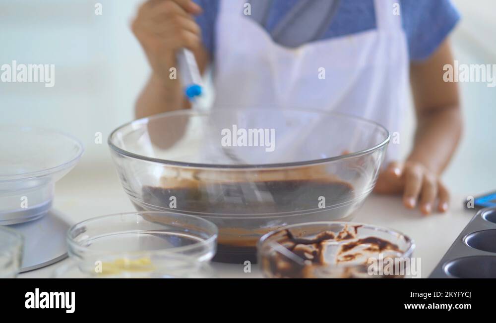 Little girl hands mixing chocolate dough Stock Video Footage - Alamy