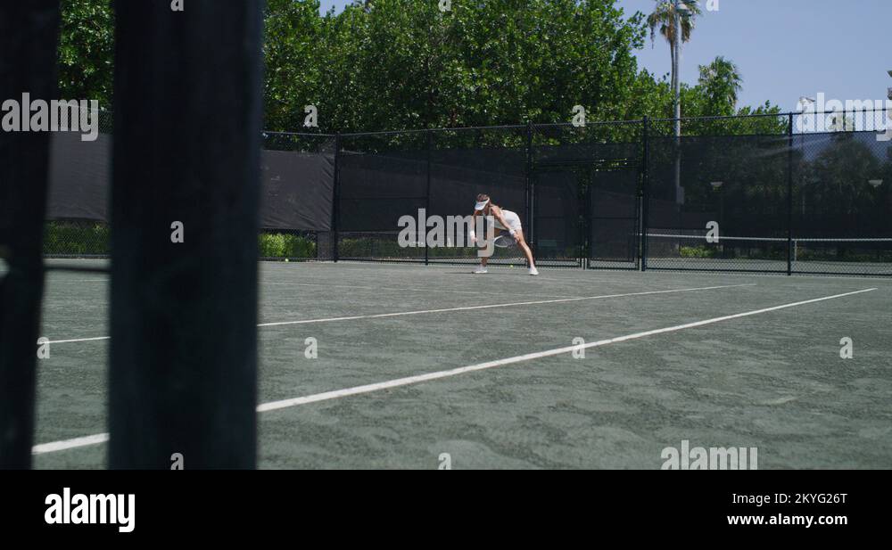 Female tennis player stretching in a tennis court Stock Video Footage ...