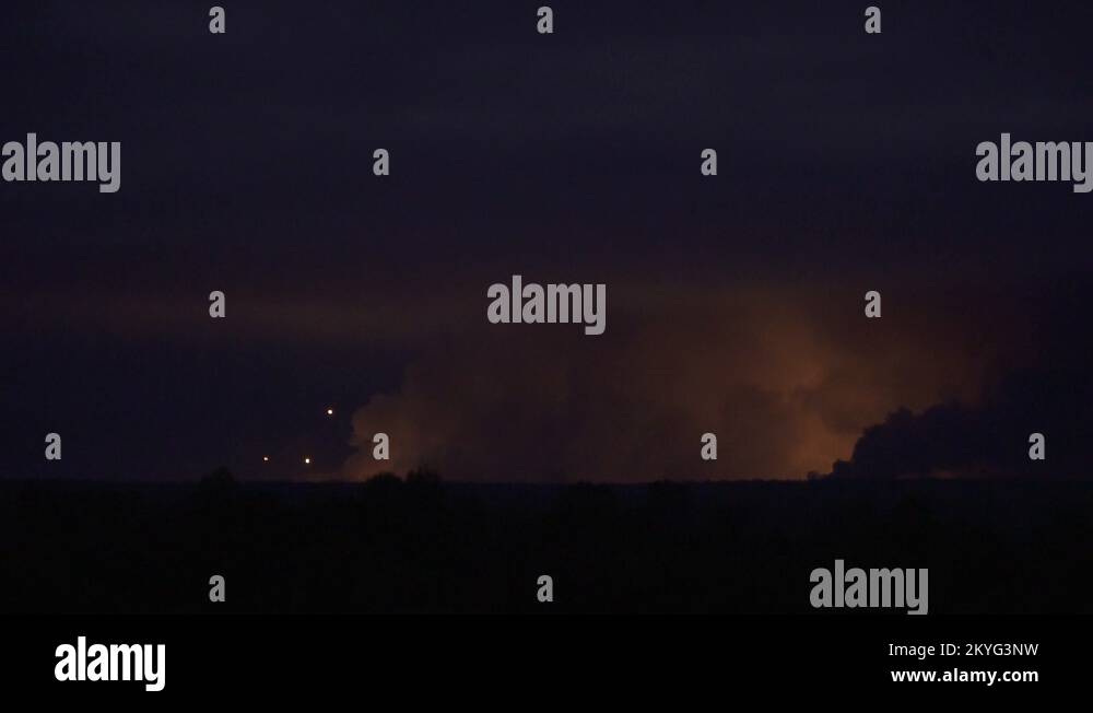Scary war zone from the distance with explosions and projectiles in the ...