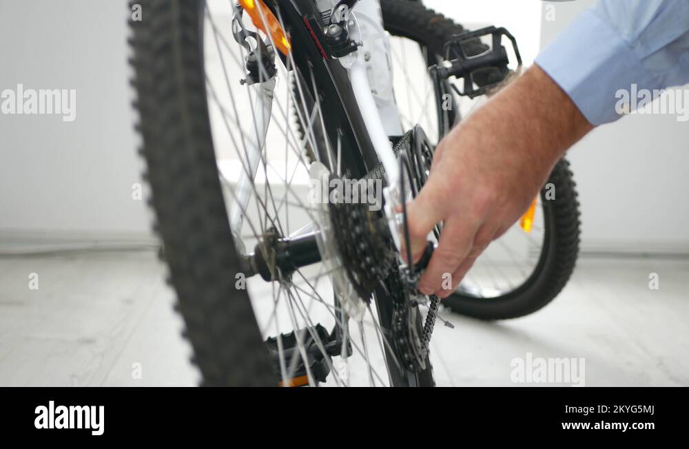 Man Spinning Bicycle Wheel and Check Chain and Speed Mechanism Stock ...