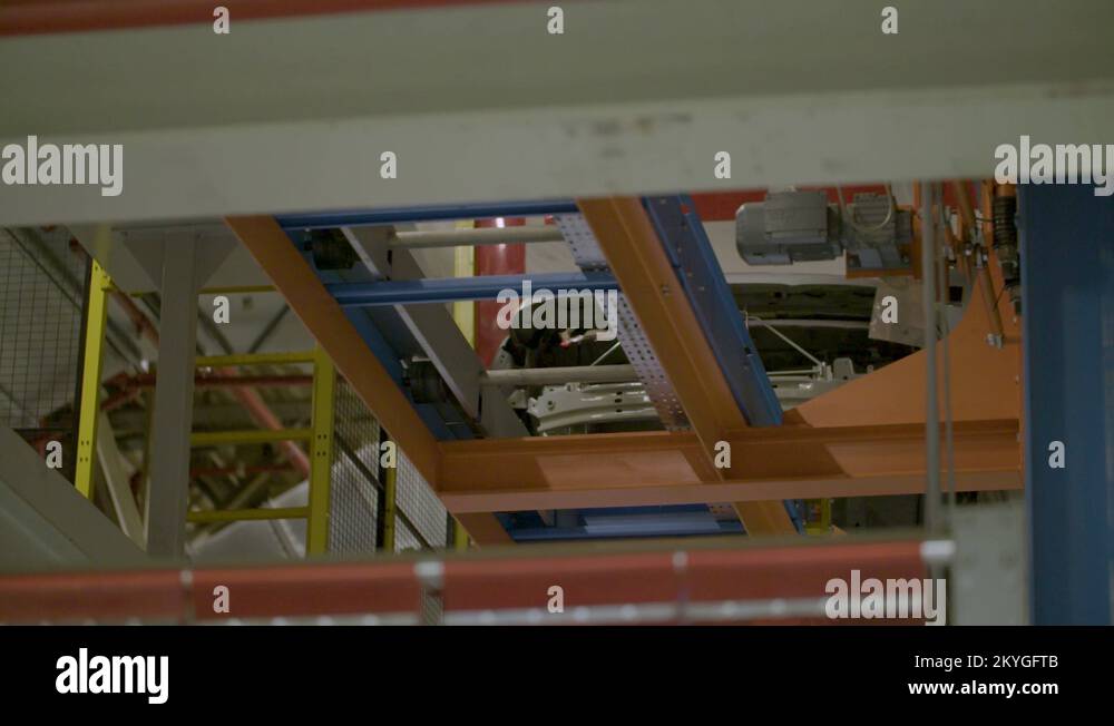 Mass production in car manufacturing industry. Car lifts for assembly ...