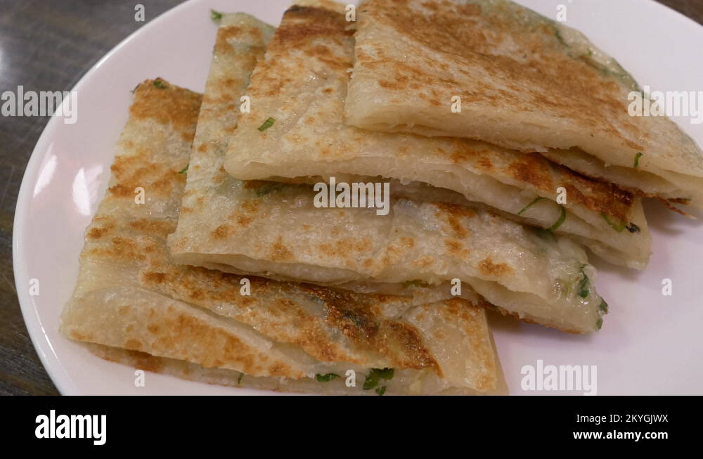 Motion of pan fried scallion cake inside Chinese restaurant with 4k ...