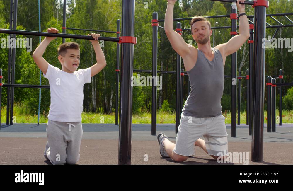 Muscular Dad Doing Pull Ups with Son Stock Video Footage - Alamy