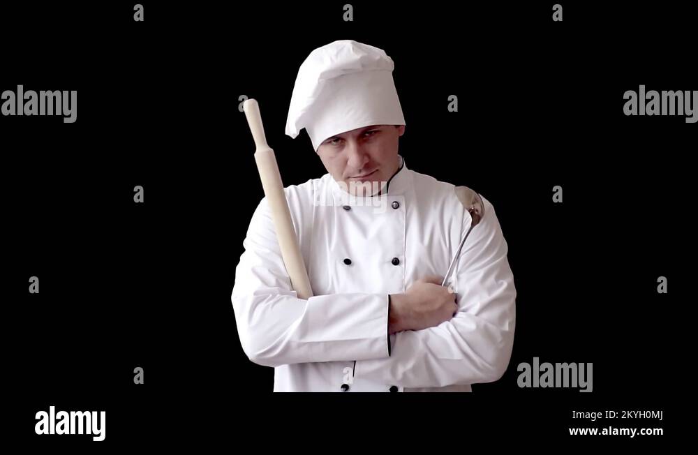 disgruntled angry chef with rolling pin in white kitchen suit on black ...