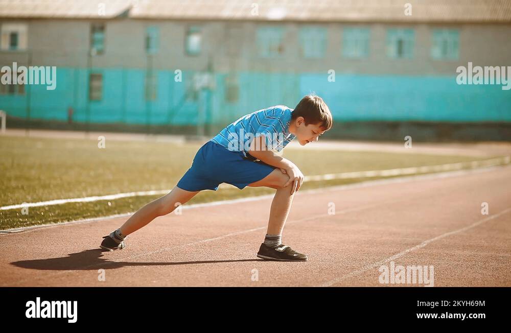 little boy playing sports in a stadium a healthy lifestyle. teen boy ...
