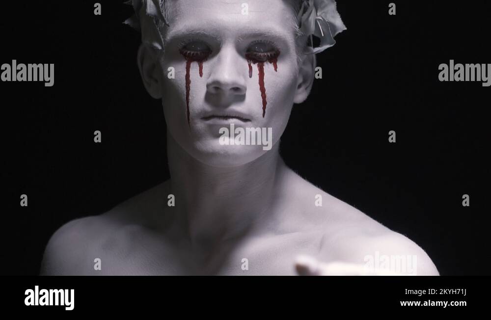 Scary statue with bloody tears on his face, reaches with his hand Stock ...