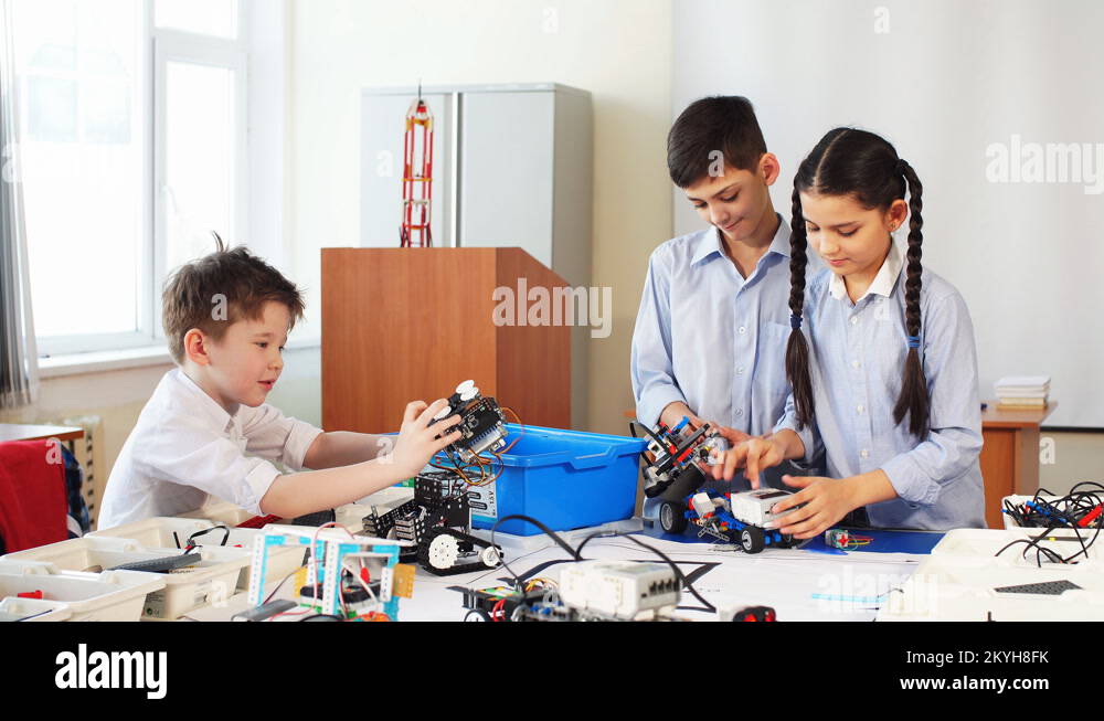 Group of kids choose parts of robotic toys for building robots at ...