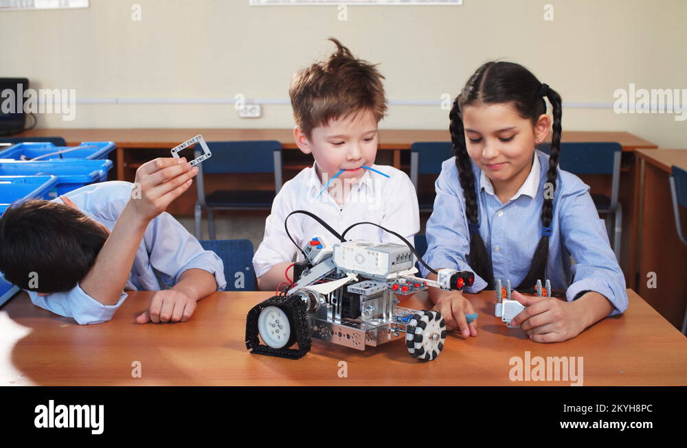 Kids playing with electrical robot while visiting robotics exhibition ...