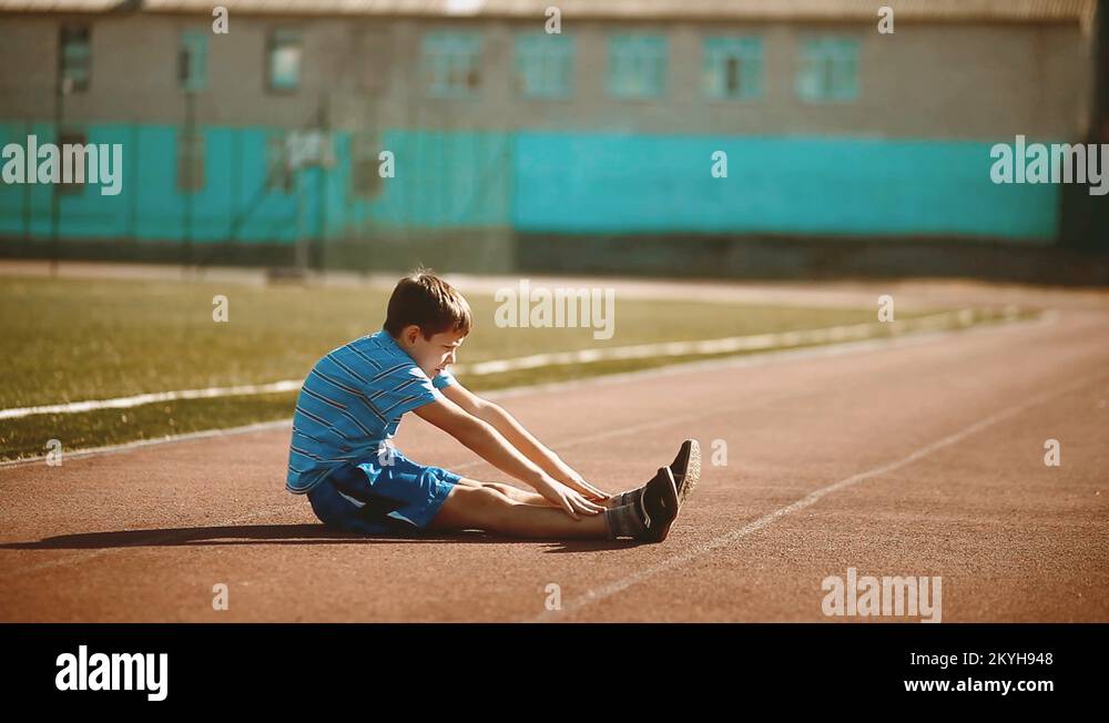 little boy playing sports in a stadium a healthy lifestyle. teen boy ...