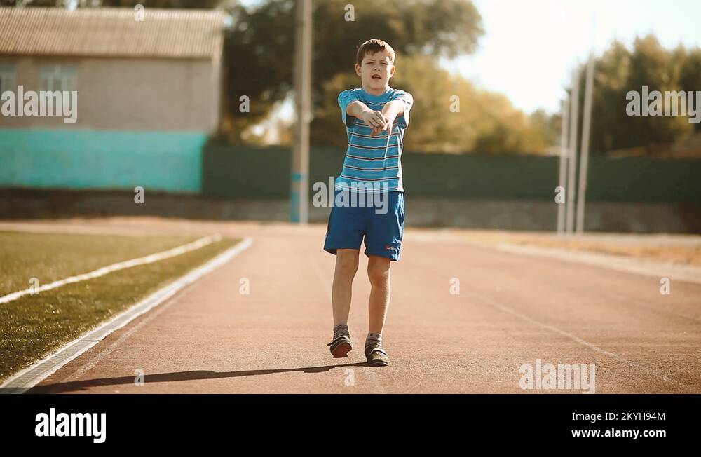 little boy playing sports in a stadium a healthy lifestyle. teen boy ...