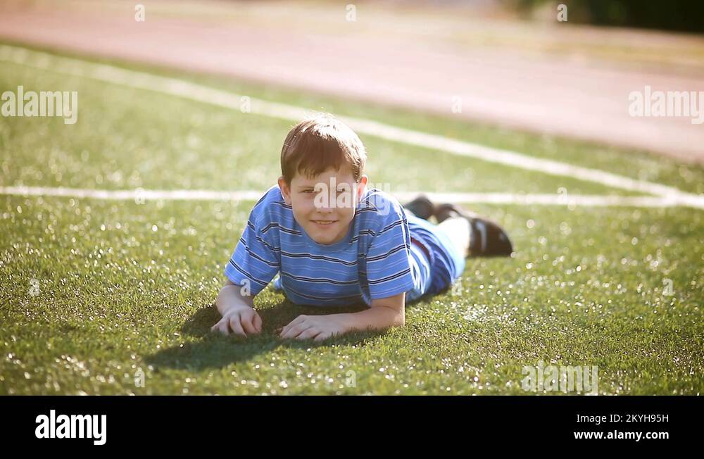 little boy wrung out at the stadium a healthy lifestyle. teen boy doing ...