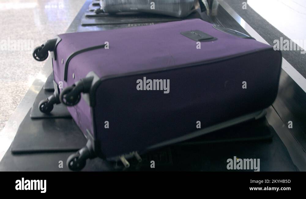 Airport baggage claim with luggage spinning around conveyor. Blurred ...