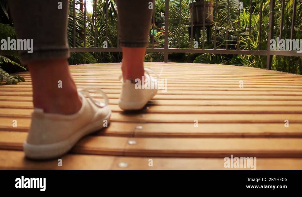 woman legs in white shoes back view on balcony determined direction ...
