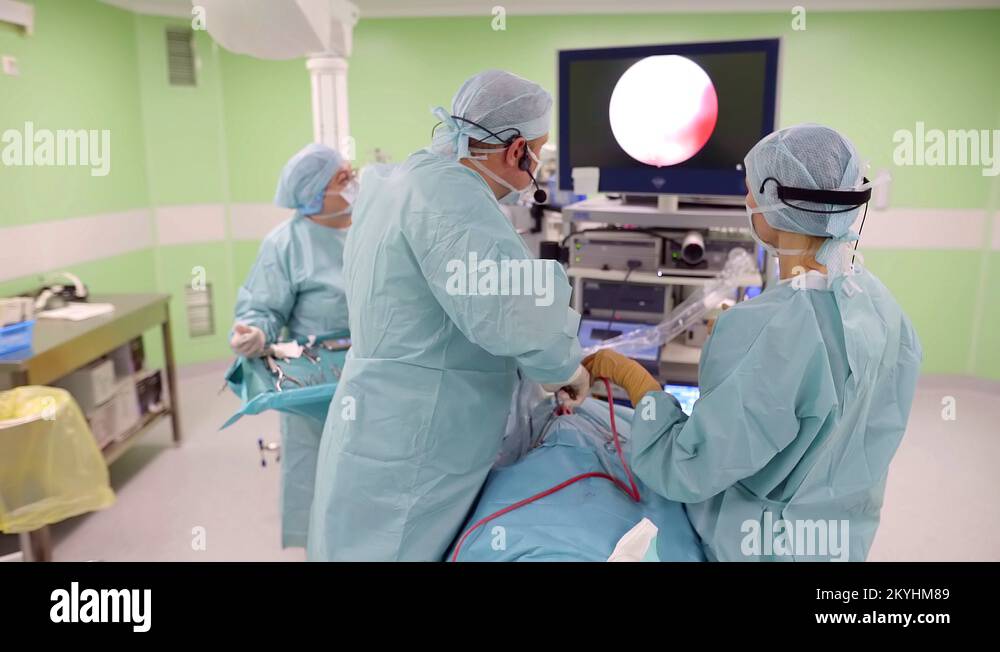 neurosurgeon is cutting brain tumor in head of patient, using ...