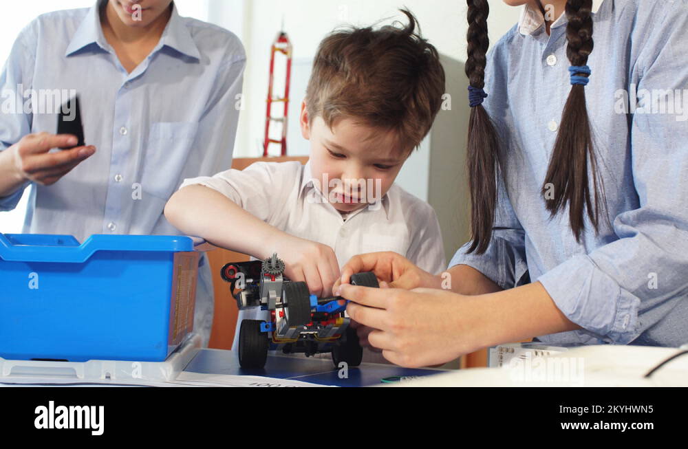 Kids playing with electrical robot while visiting robotics exhibition ...