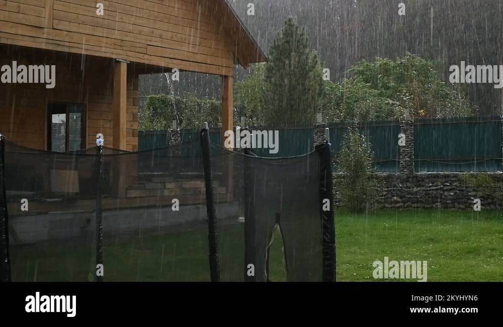 Heavy rain shower in backyard at unfinished house. slow motion Stock ...