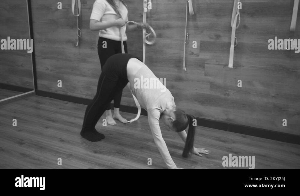 Coach helps to perform stretching exercises Stock Video Footage - Alamy