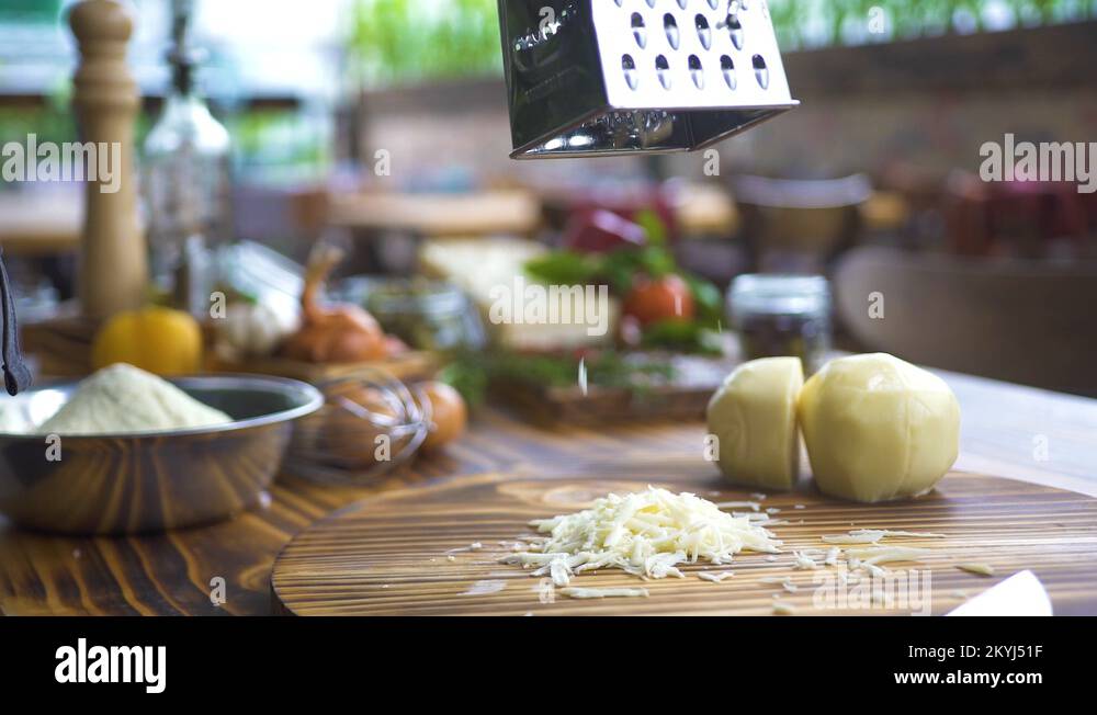 Grating cheese on grater slow motion. Close up grating dairy cheese on ...