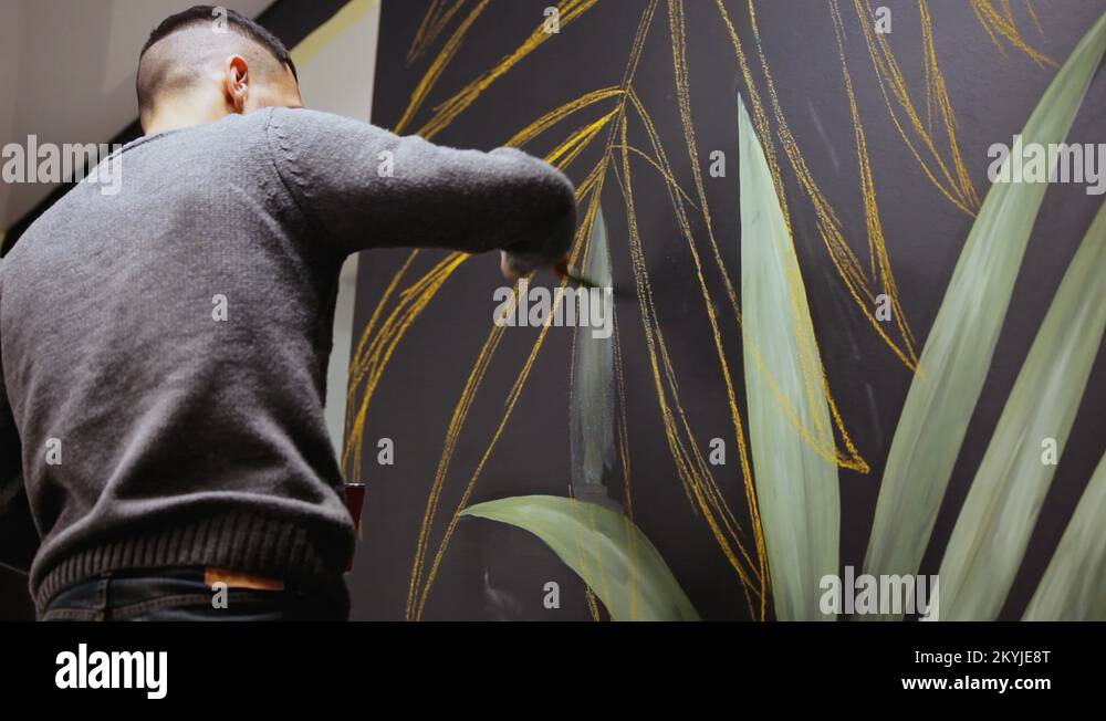 Graffiti artist drawing with paint on wall. Art wall painting. Art ...